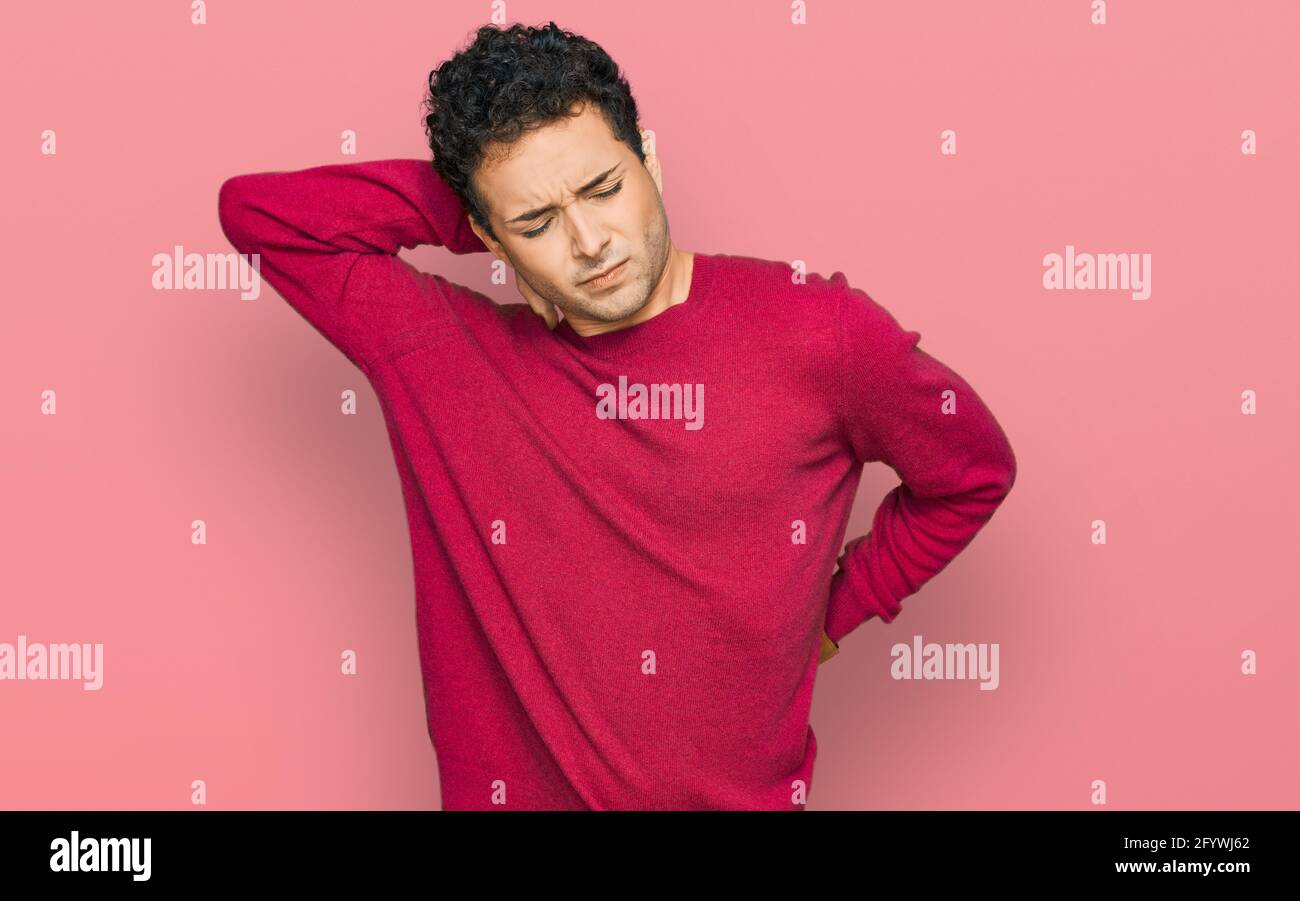 Young handsome man wearing casual clothes suffering of neck ache injury ...
