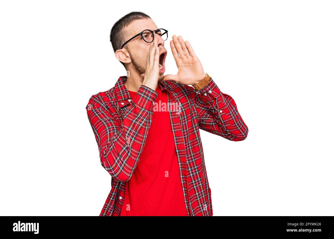 Hispanic young man wearing casual clothes shouting angry out loud with ...