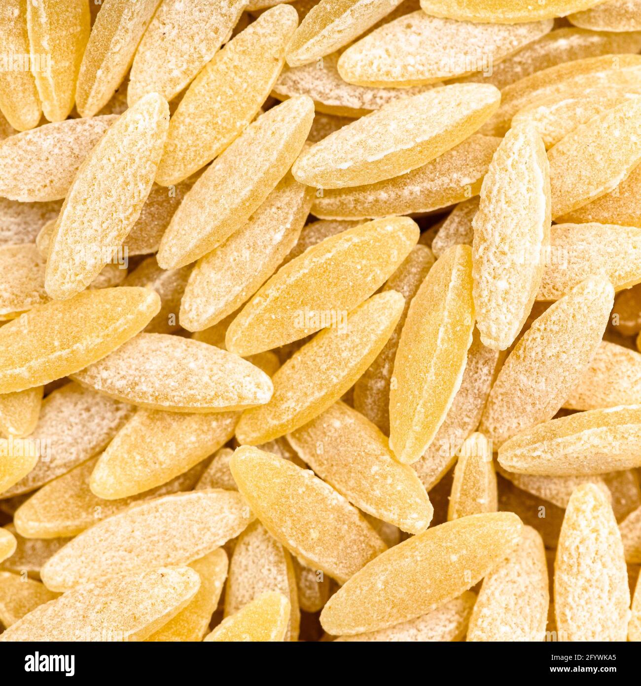 square food background - uncooked orzo risoni pasta close up Stock ...