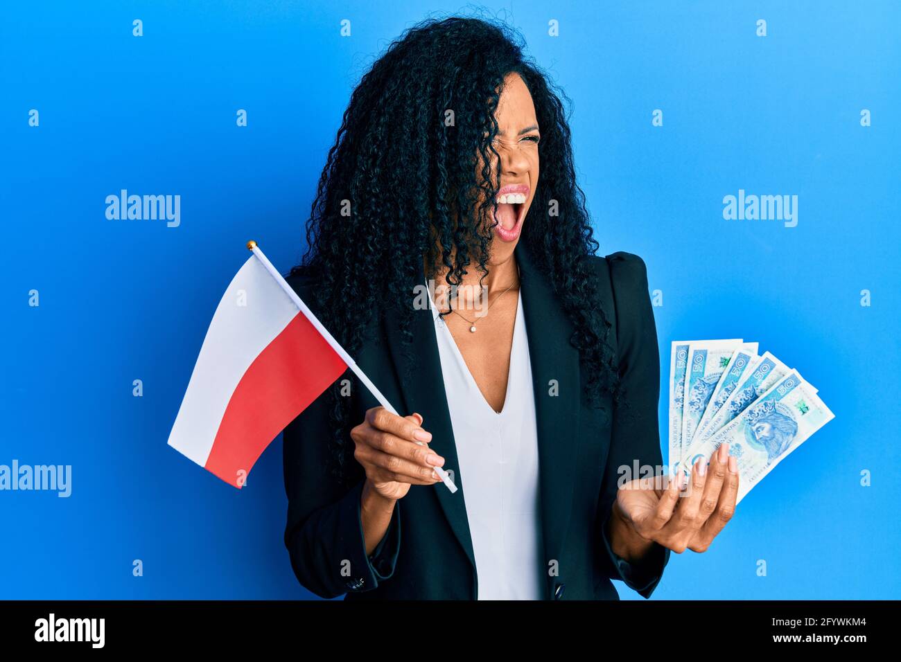 Middle age african american woman holding poland flag and zloty ...