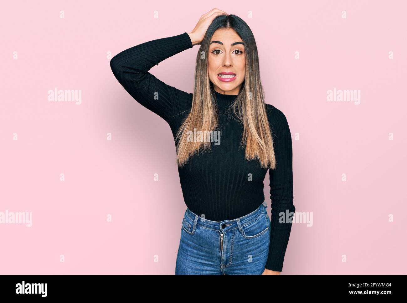 Young hispanic woman wearing casual clothes confuse and wonder about ...