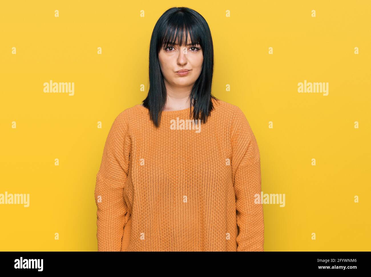 Young hispanic woman wearing casual clothes skeptic and nervous ...