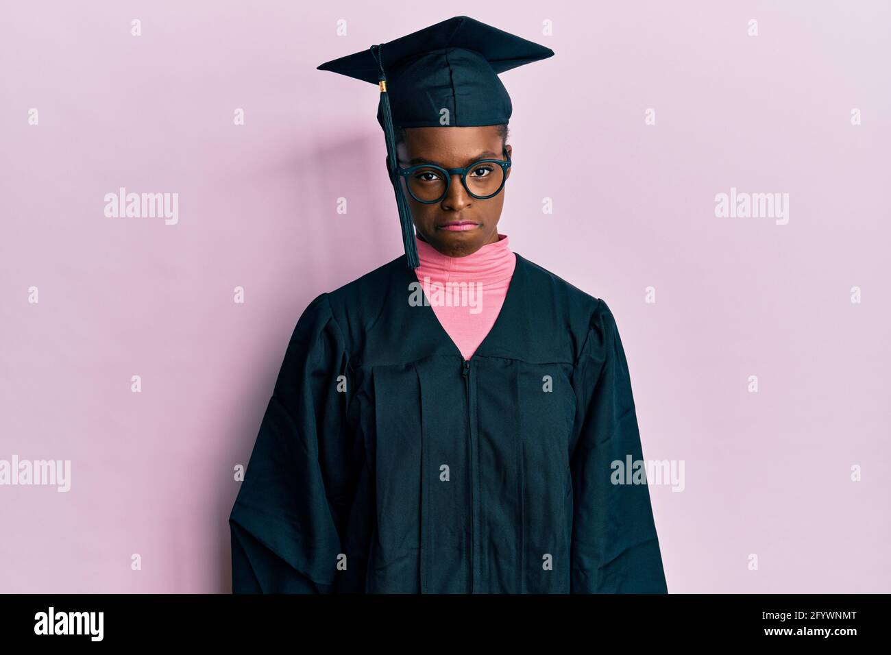 Young african american girl wearing graduation cap and ceremony robe ...