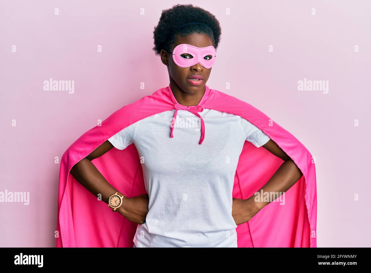 Young african american girl wearing super hero costume and medical mask ...