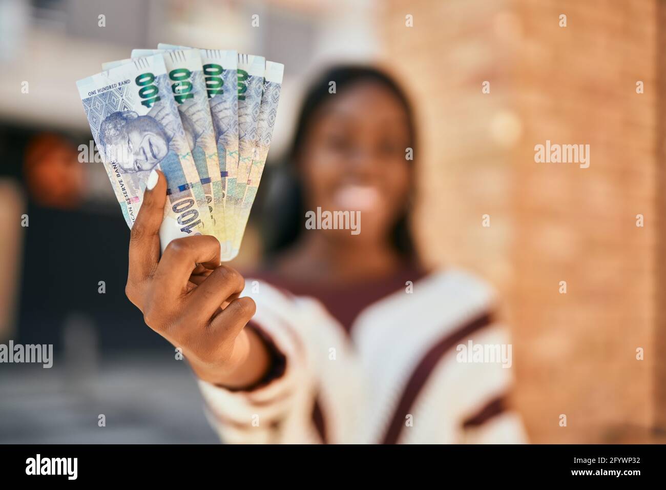 Young african american woman smiling happy holding south africa rands at the city Stock Photo ...