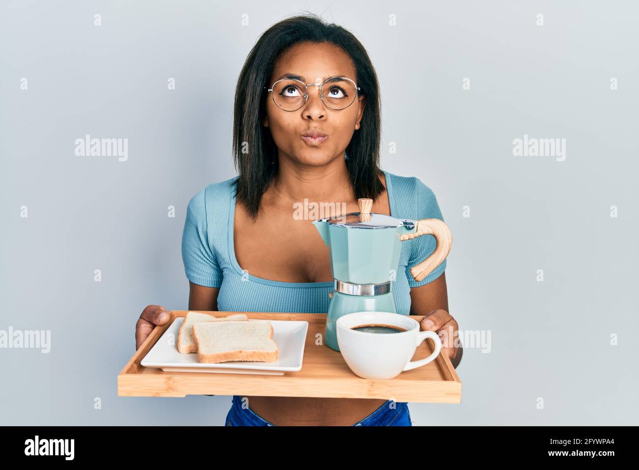 Young african american girl holding tray with breakfast food making ...