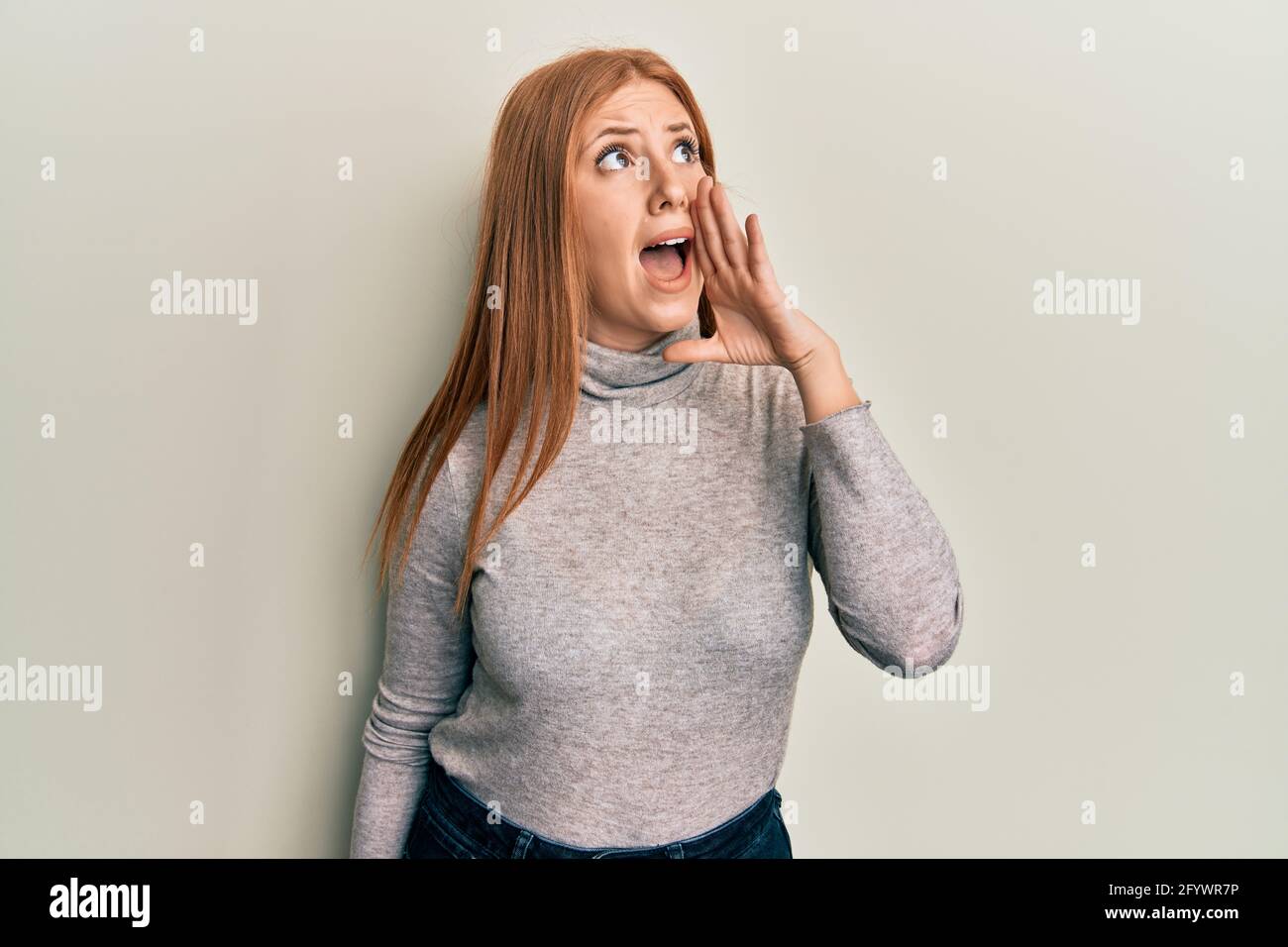 Young irish woman wearing casual clothes shouting and screaming loud to ...