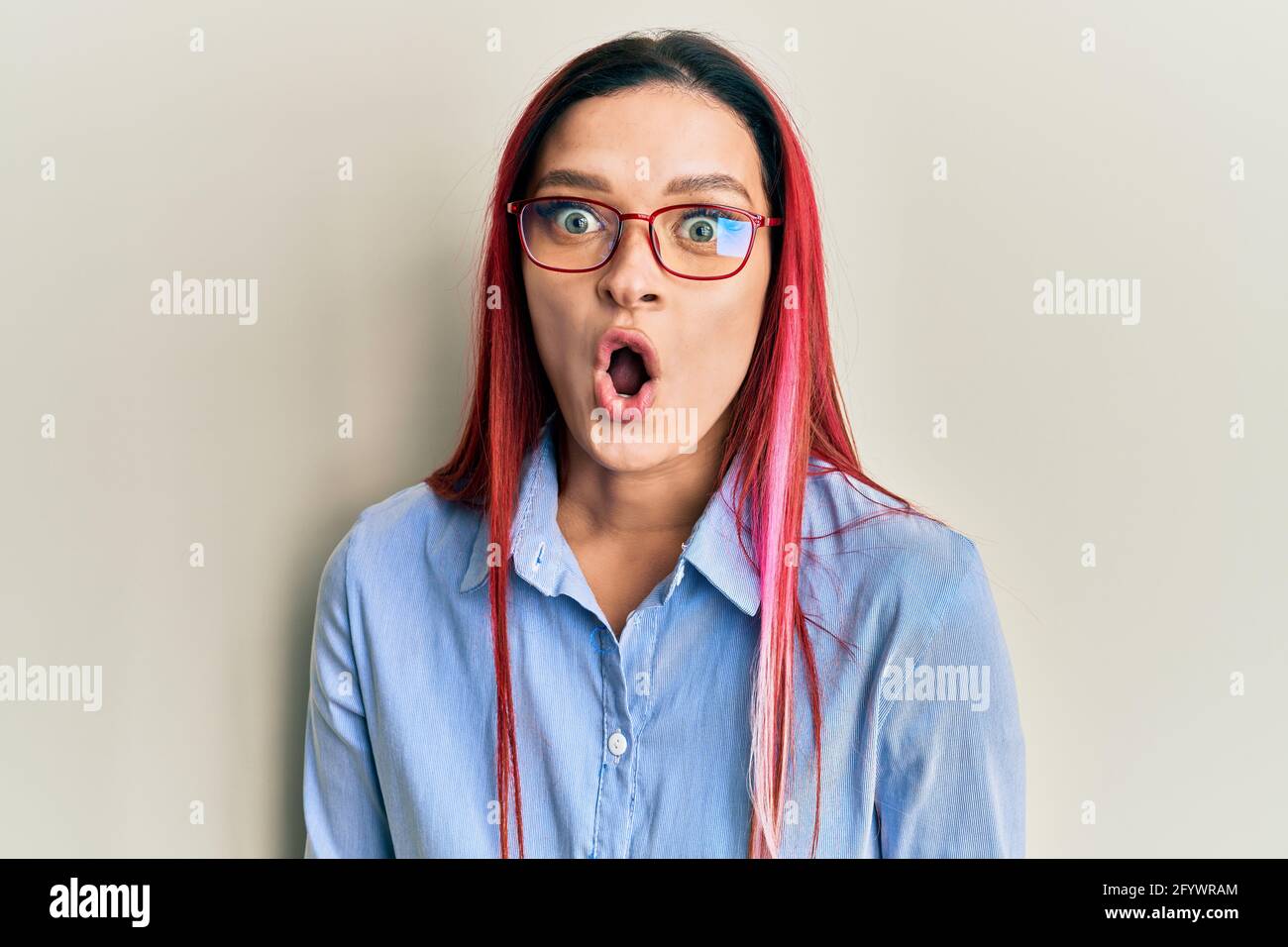 Young caucasian woman wearing casual clothes and glasses afraid and ...
