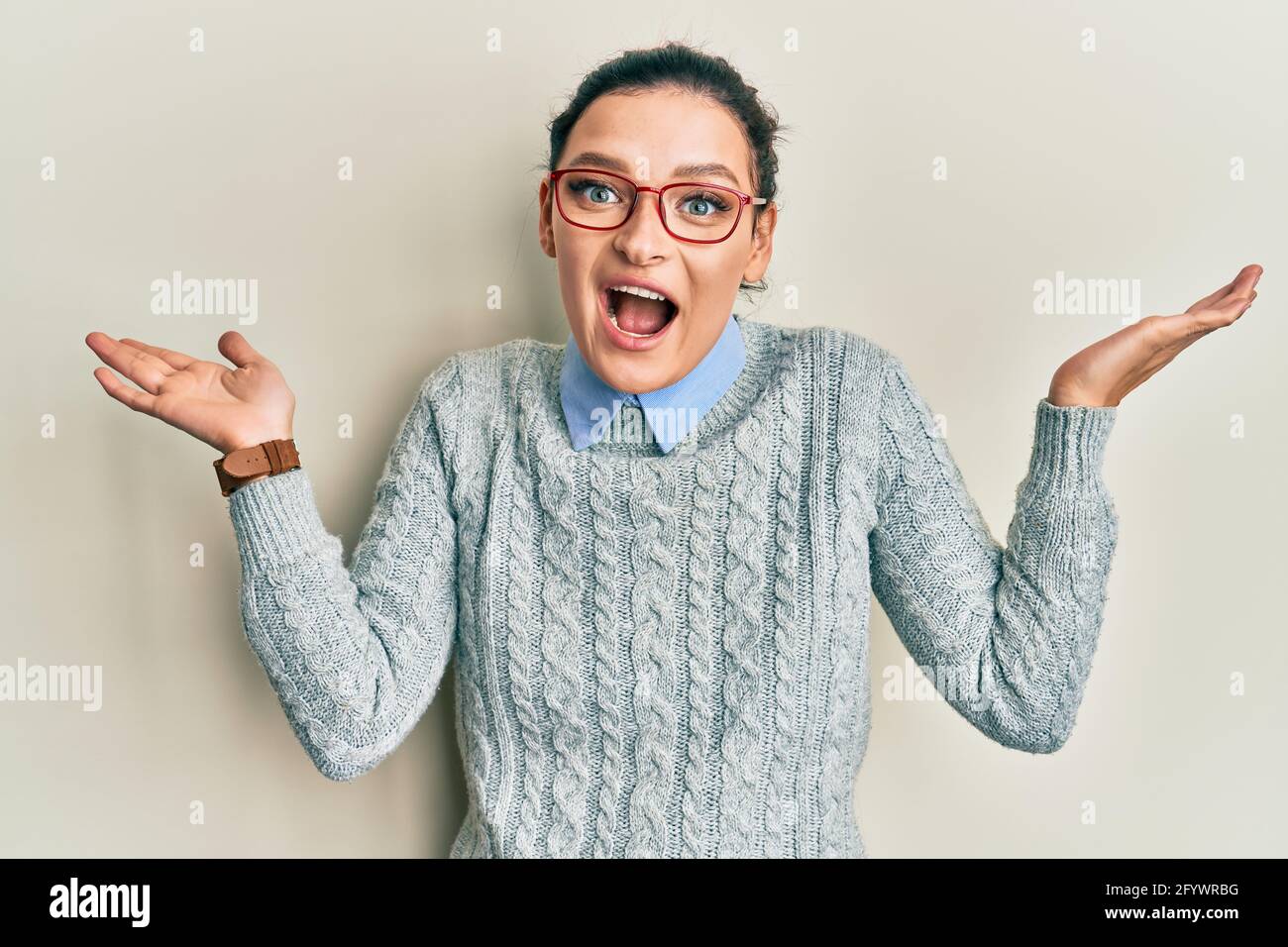 Young caucasian woman wearing casual clothes and glasses celebrating ...