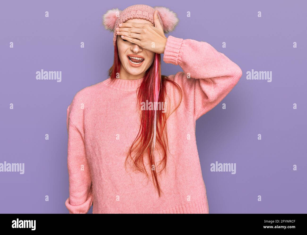 Young caucasian woman wearing casual clothes and wool cap smiling and ...