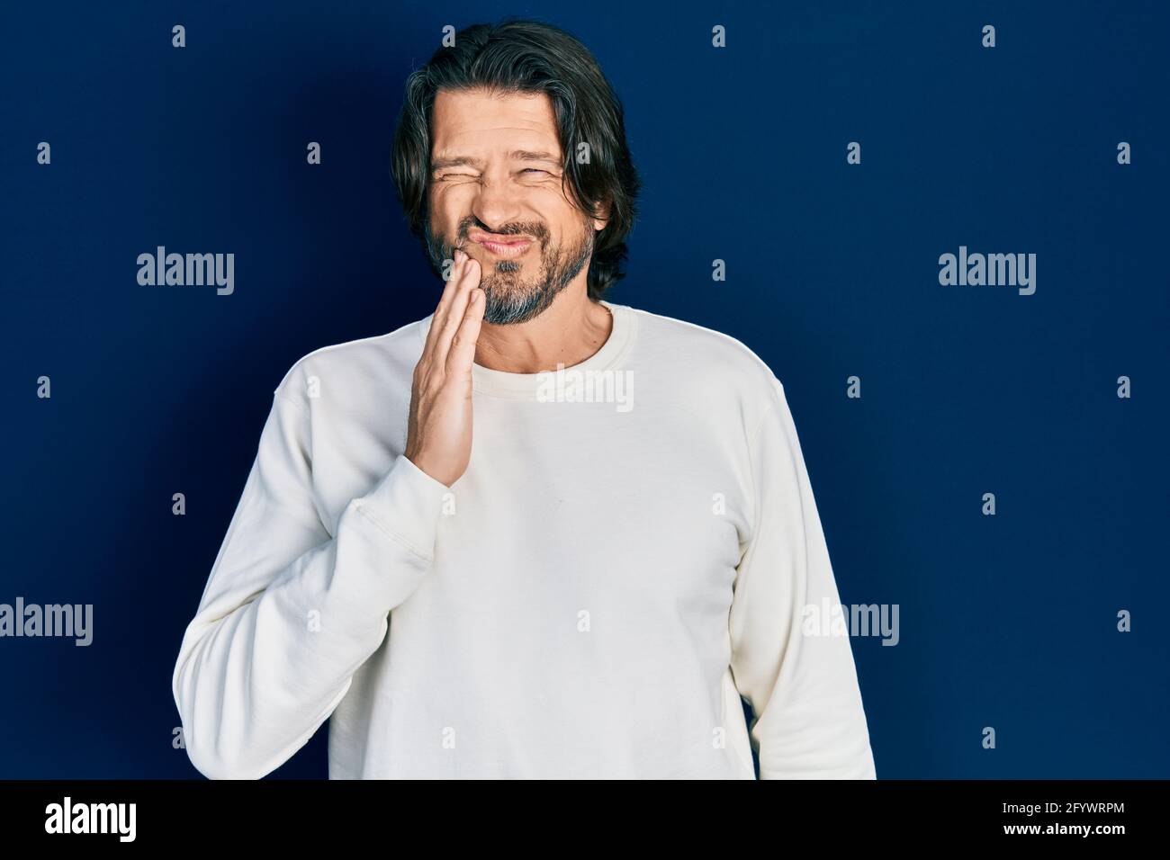 Middle age caucasian man wearing casual clothes touching mouth with ...