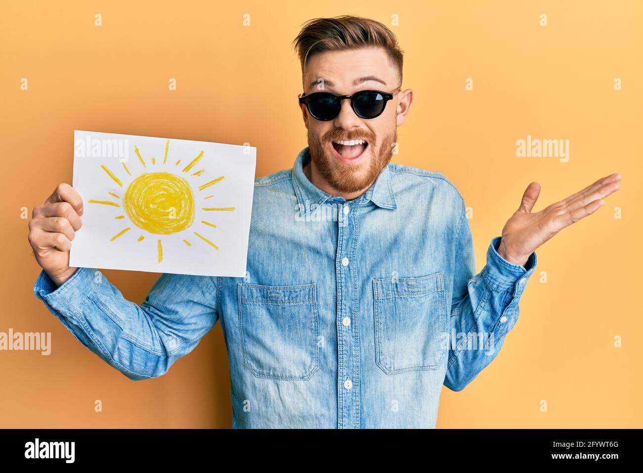 Young Redhead Man Holding Sun Draw Wearing Sunglasses Celebrating