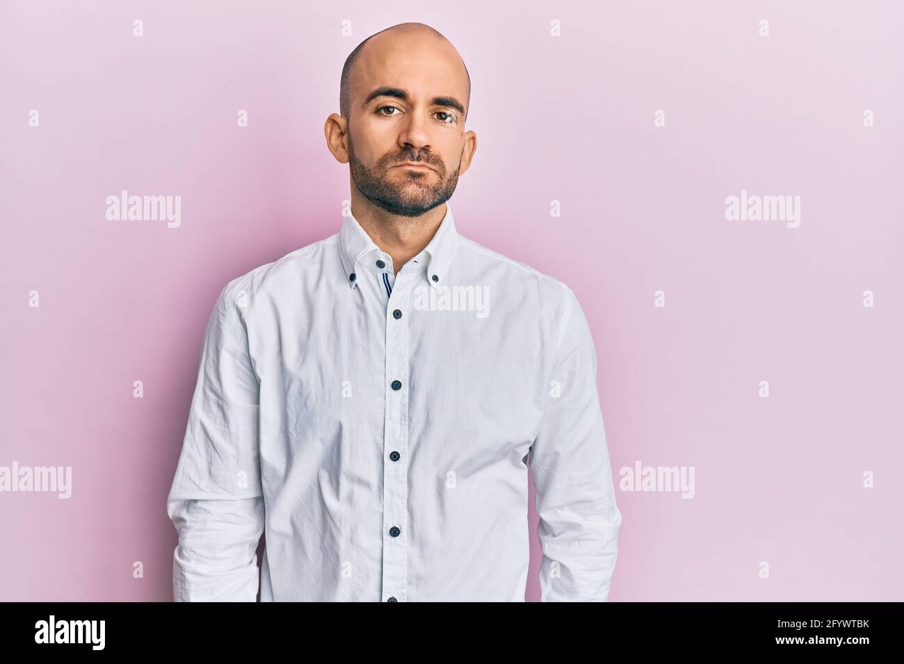 Young hispanic man wearing casual clothes relaxed with serious ...