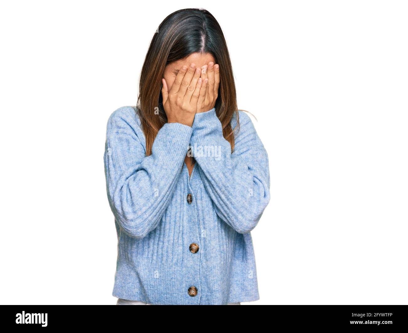 Young woman wearing casual clothes with sad expression covering face ...
