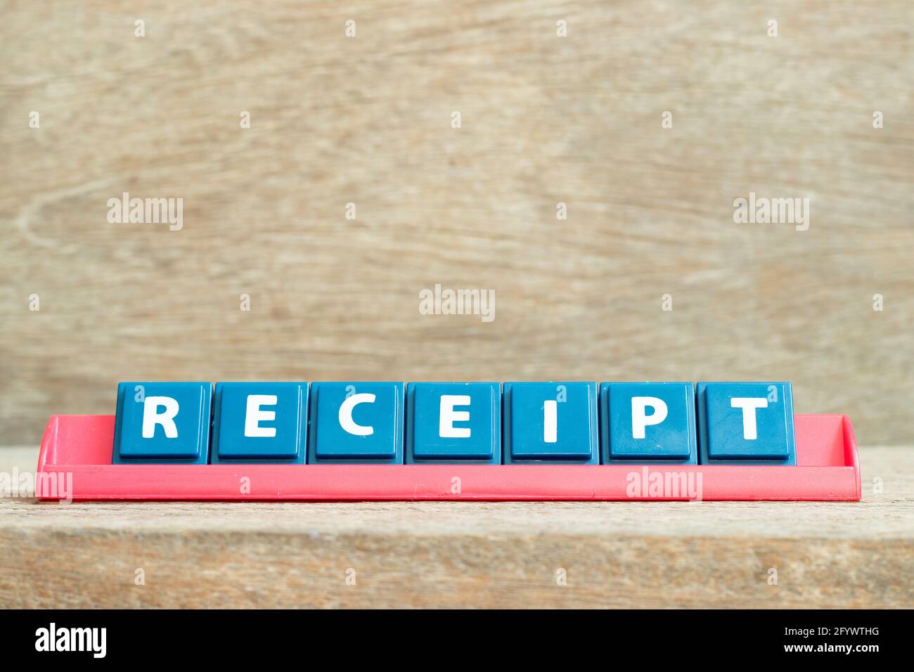 Tile alphabet letter with word receipt in red color rack on wood ...