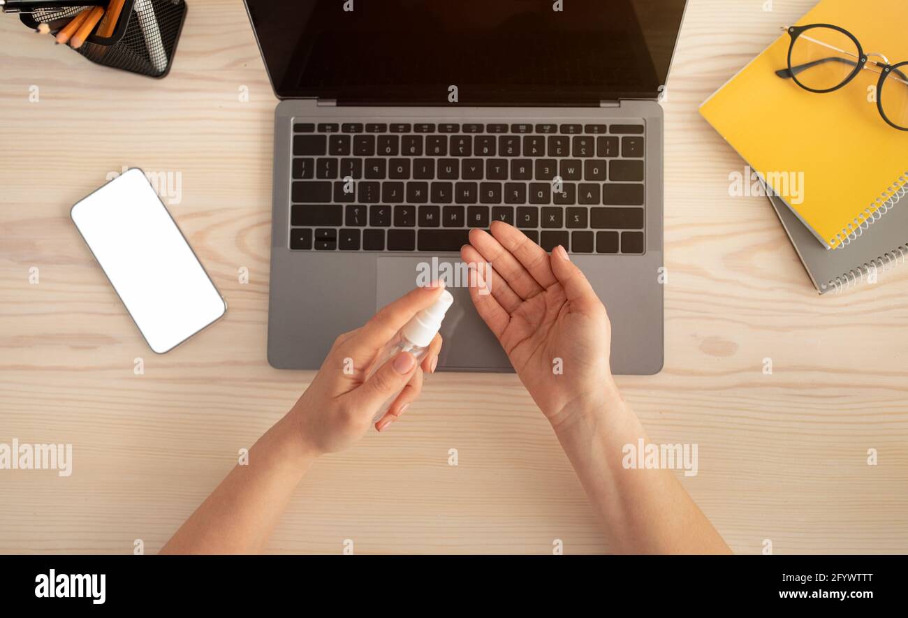 Female hands with disinfectant mist spray, cleaning palms with ...