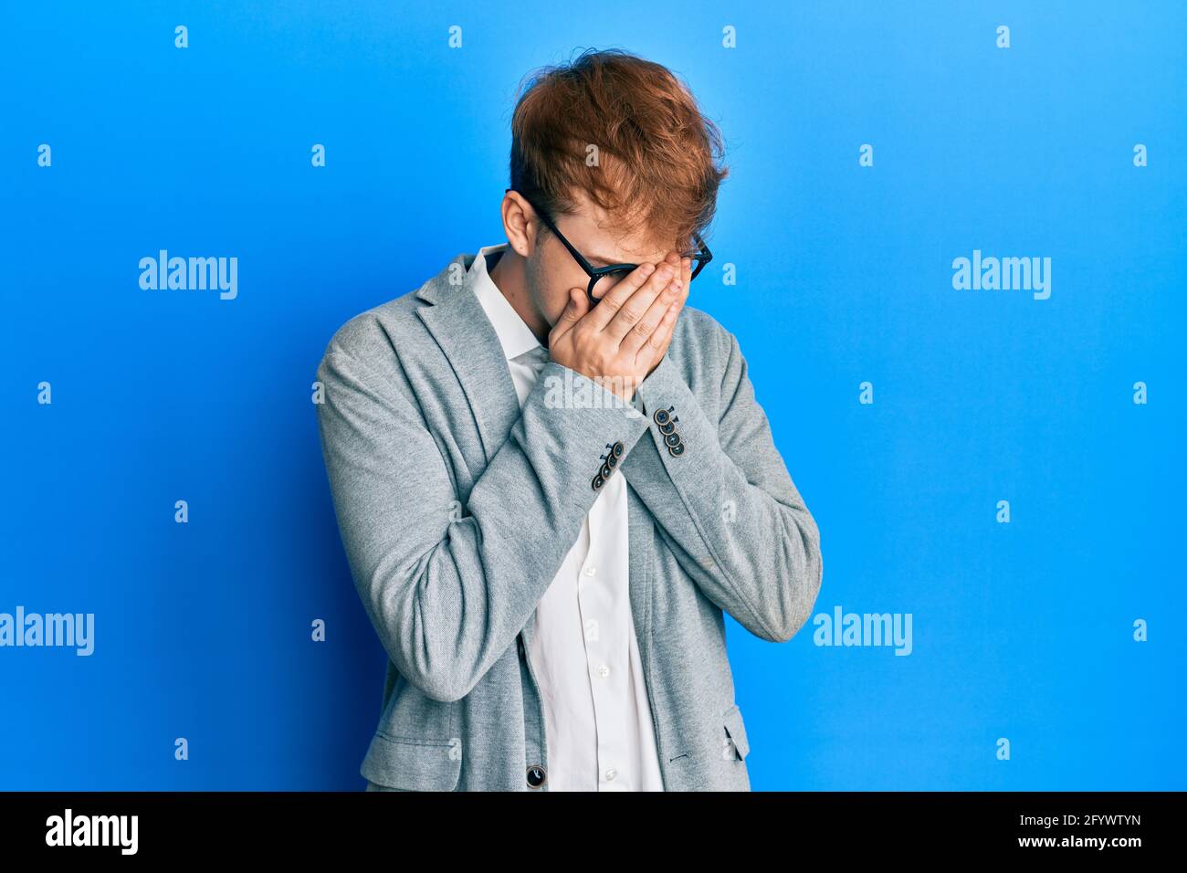Young caucasian man wearing elegant clothes and glasses with sad ...