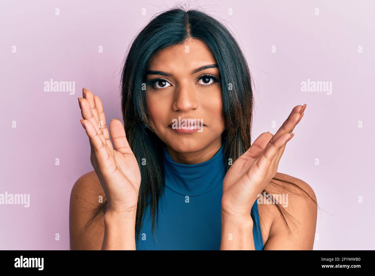 Young latin transsexual transgender woman with hands over face ...