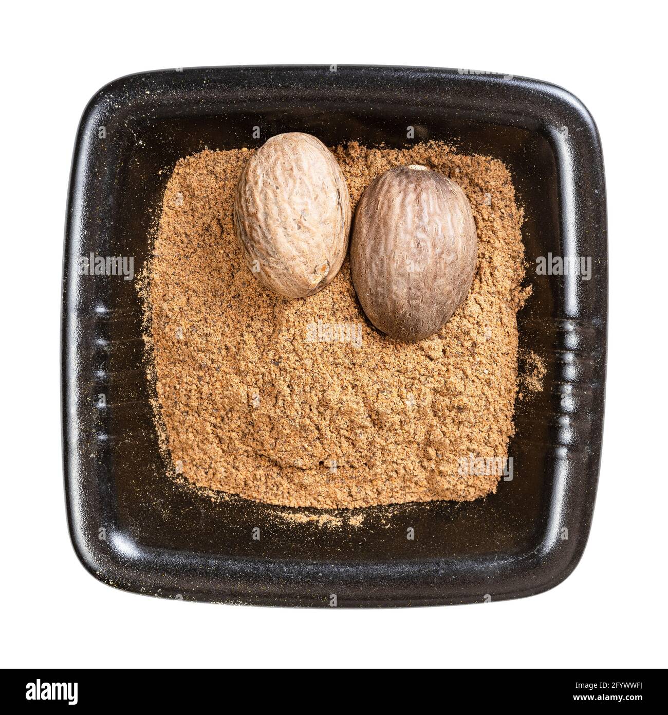 top view of whole nutmeg seeds and powder in black bowl isolated on ...