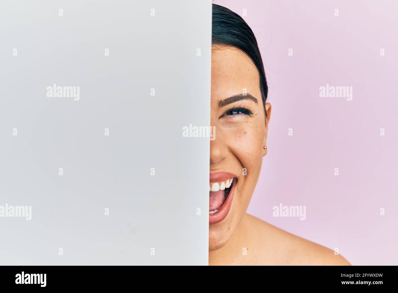 Beautiful brunette woman holding blank empty banner covering half face ...