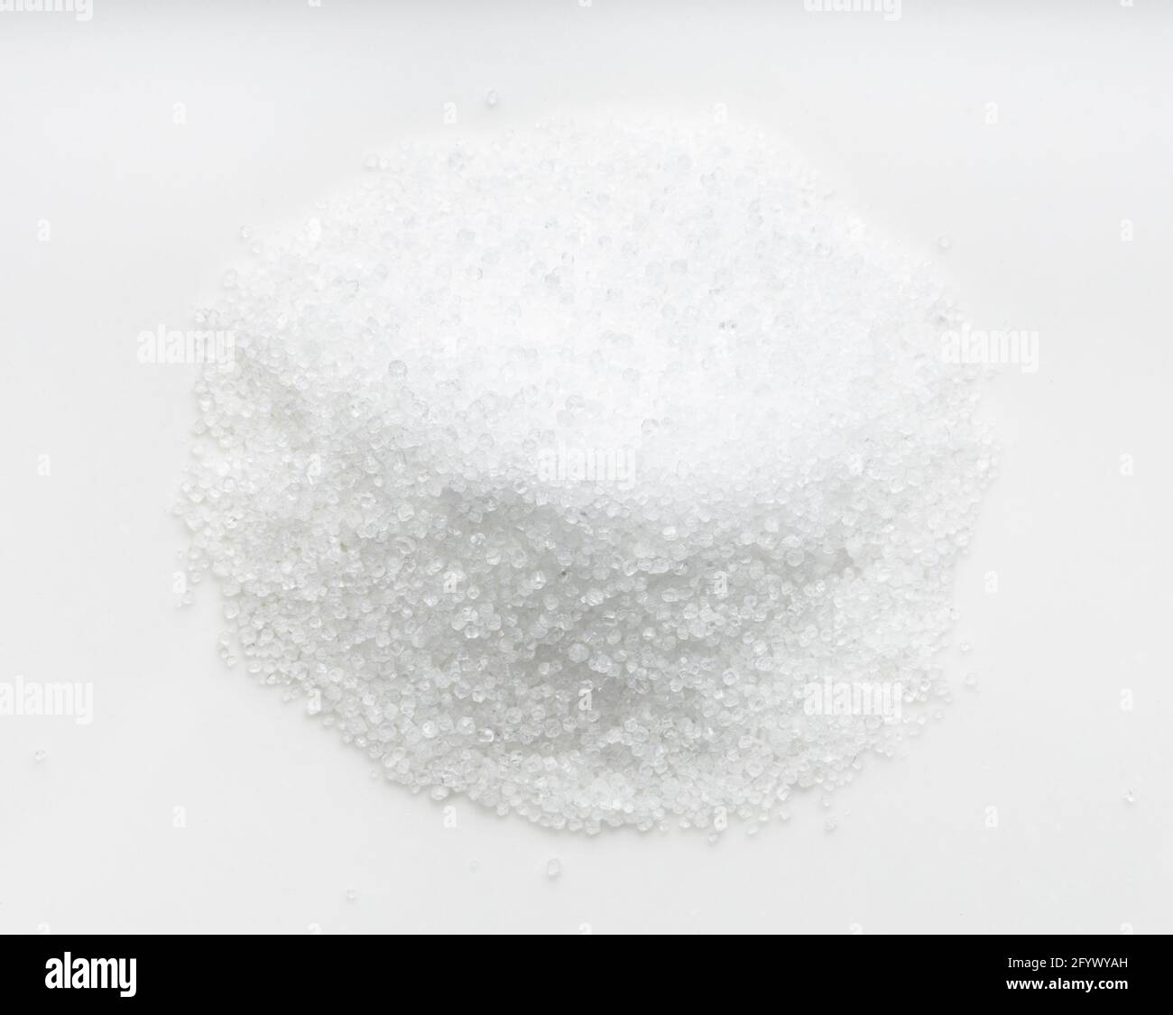 top view of pile of crystalline fructose close up on gray ceramic plate ...
