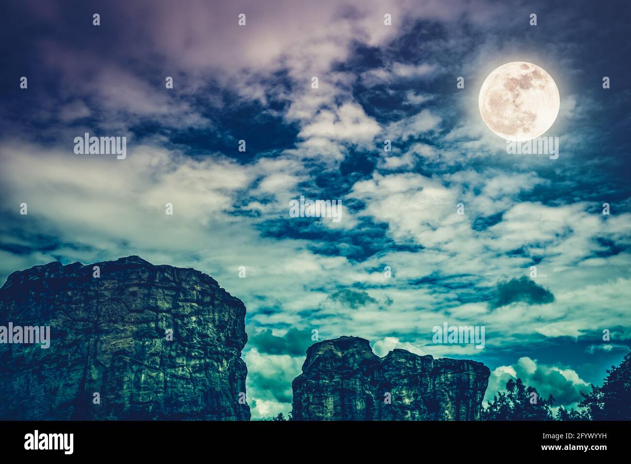 Boulder with sky background and beautiful full moon behind cloud at ...