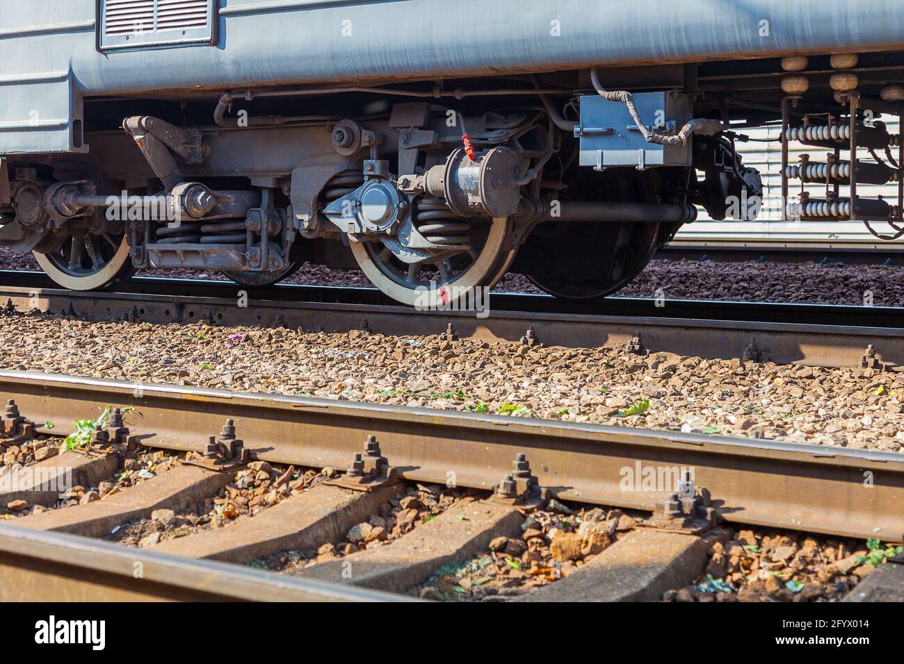 Wheels of a railway train. In the foreground the rails of the oncoming track Stock Photo - Alamy