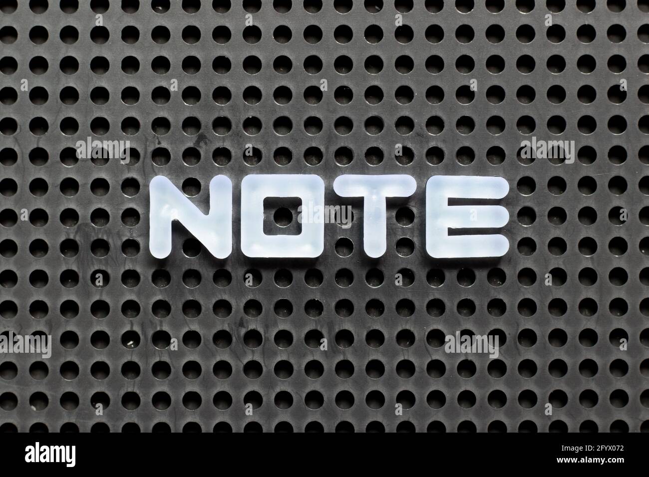 White color letter in word note on black pegboard background Stock ...