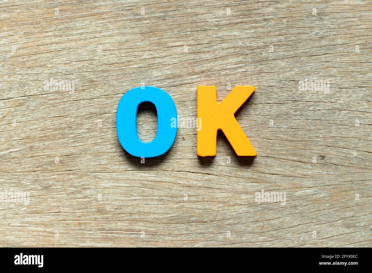 Color alphabet letter in word ok on wood background Stock Photo - Alamy