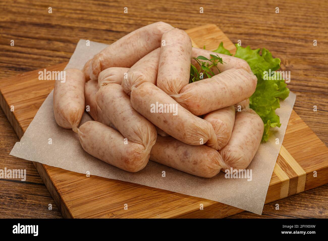 Raw natural chicken baby sausages for roast Stock Photo - Alamy