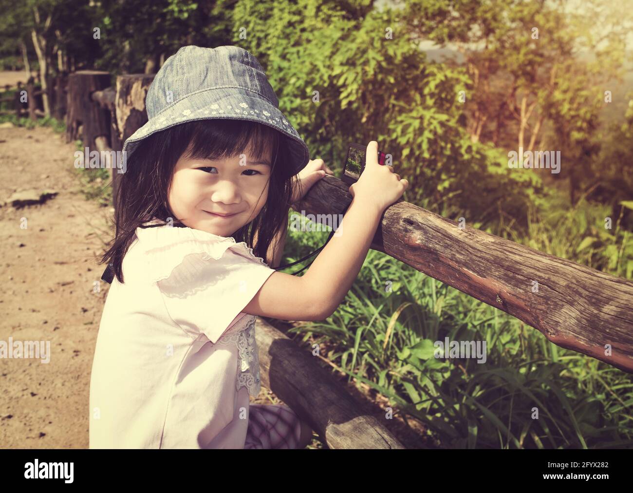 Happy chinese girl smiling and learning take photographs nature by ...