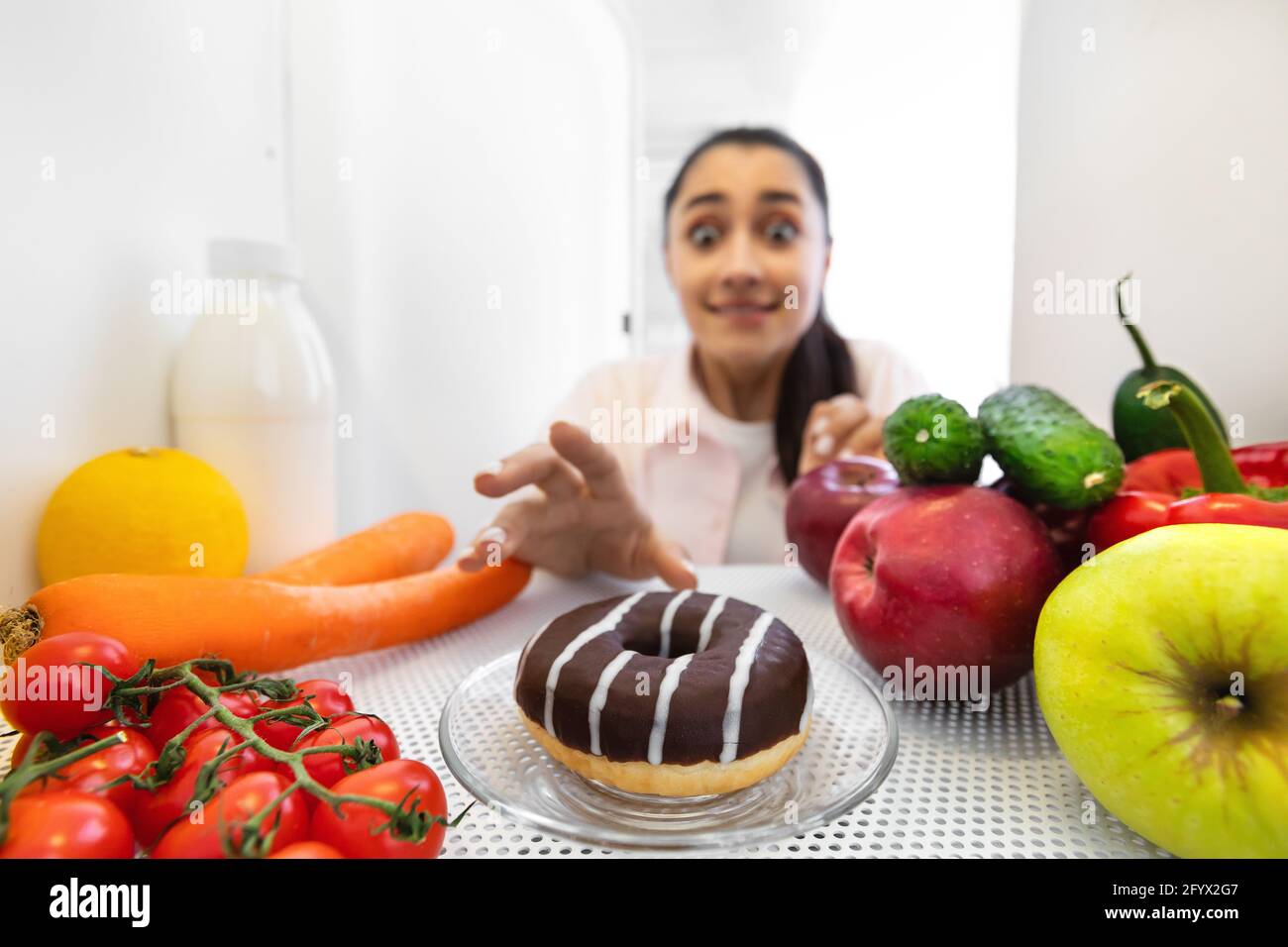 Woman grabbing donut hi-res stock photography and images - Alamy