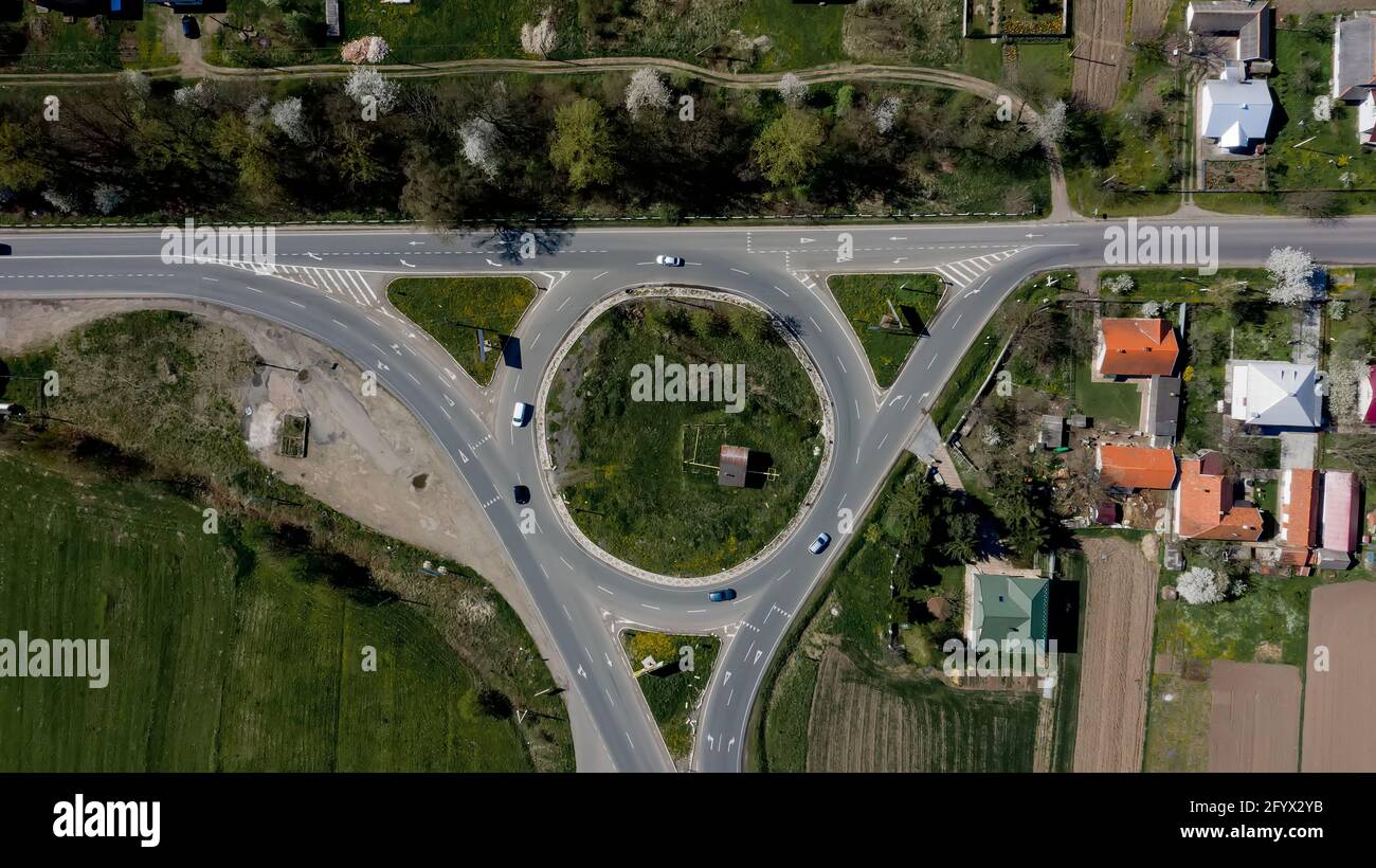 Roundabout traffic of cars and trucks on the circle ring road aerial ...