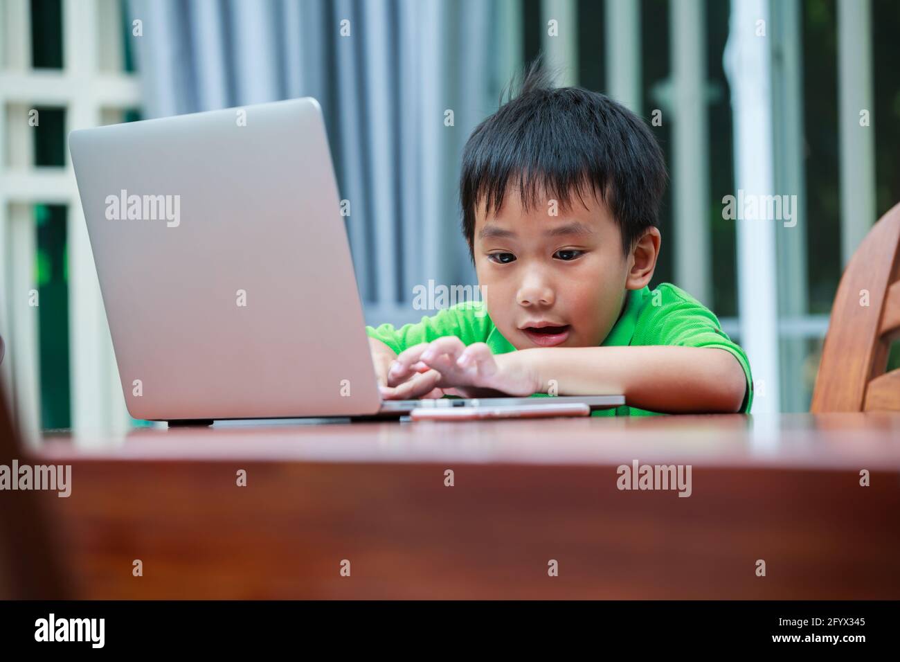 Happy asian child. Handsome boy enjoying modern generation technologies ...