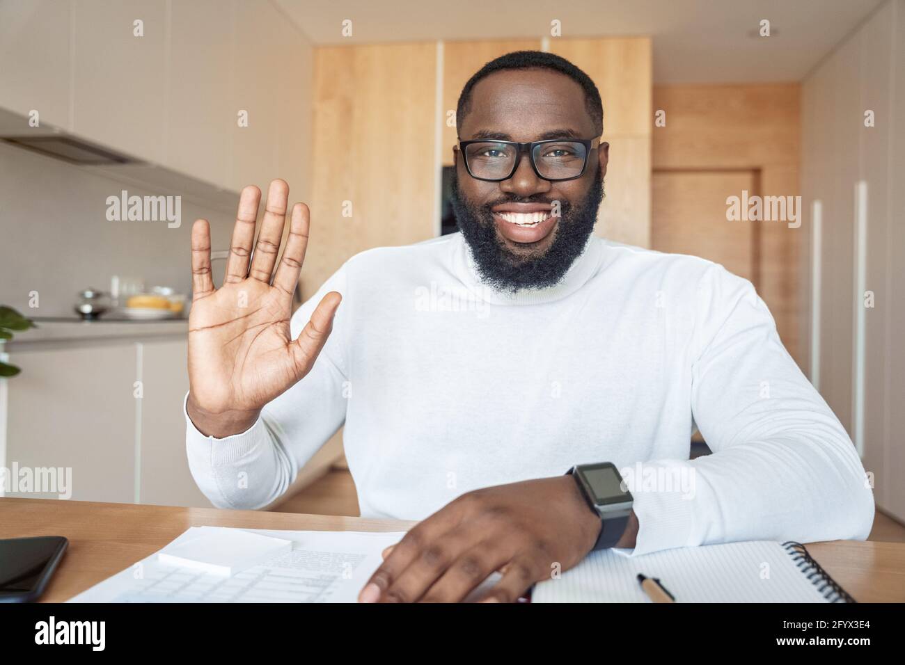 Headshot portrait of young african amercian man saying hi smiling to camera Stock Photo - Alamy
