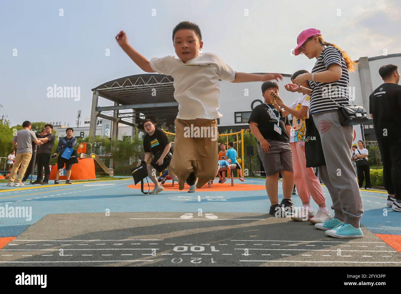 Shanghai, China. 30th May, 2021. A boy tries long jump at a sports park ...