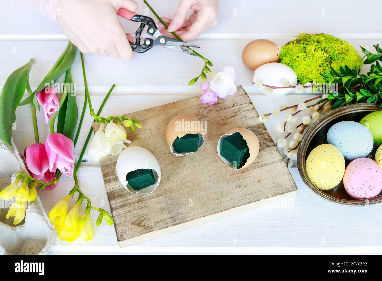 Florist at work: woman shows how to make Easter floral decoration with ...