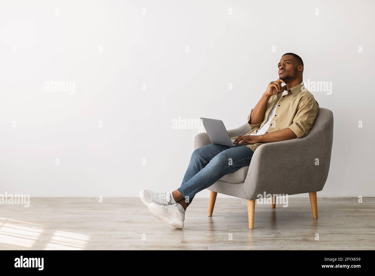 Pensive Black Guy With Laptop Computer Thinking About Work Indoors ...