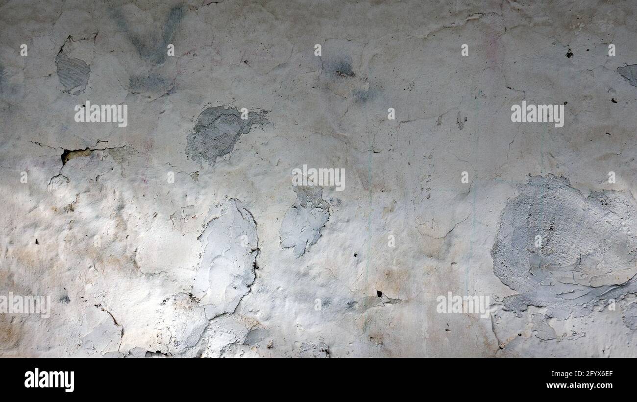 Old cracked and damaged stucco wall surface as background and texture ...