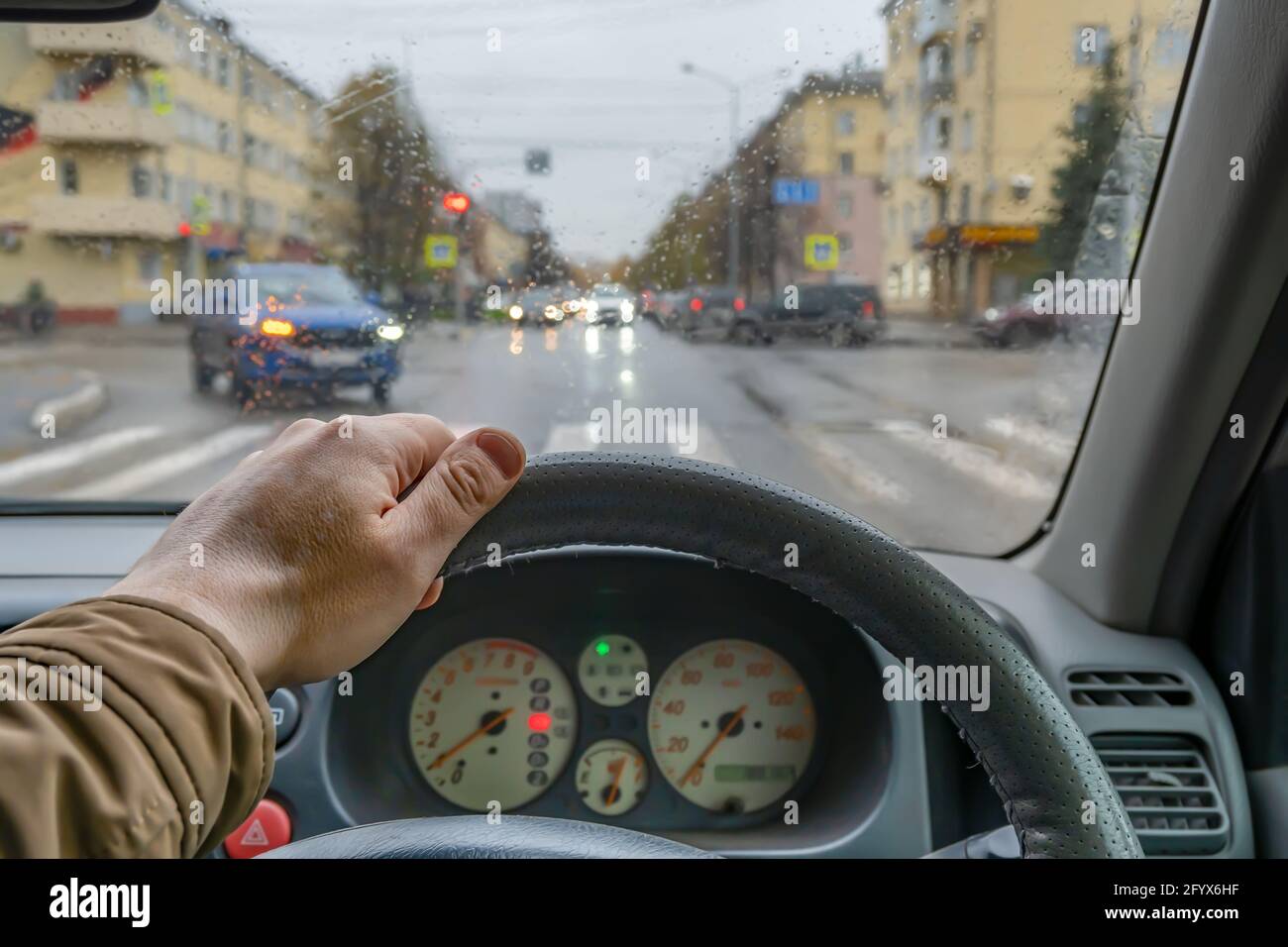 driver hand on the steering wheel inside the car Stock Photo - Alamy