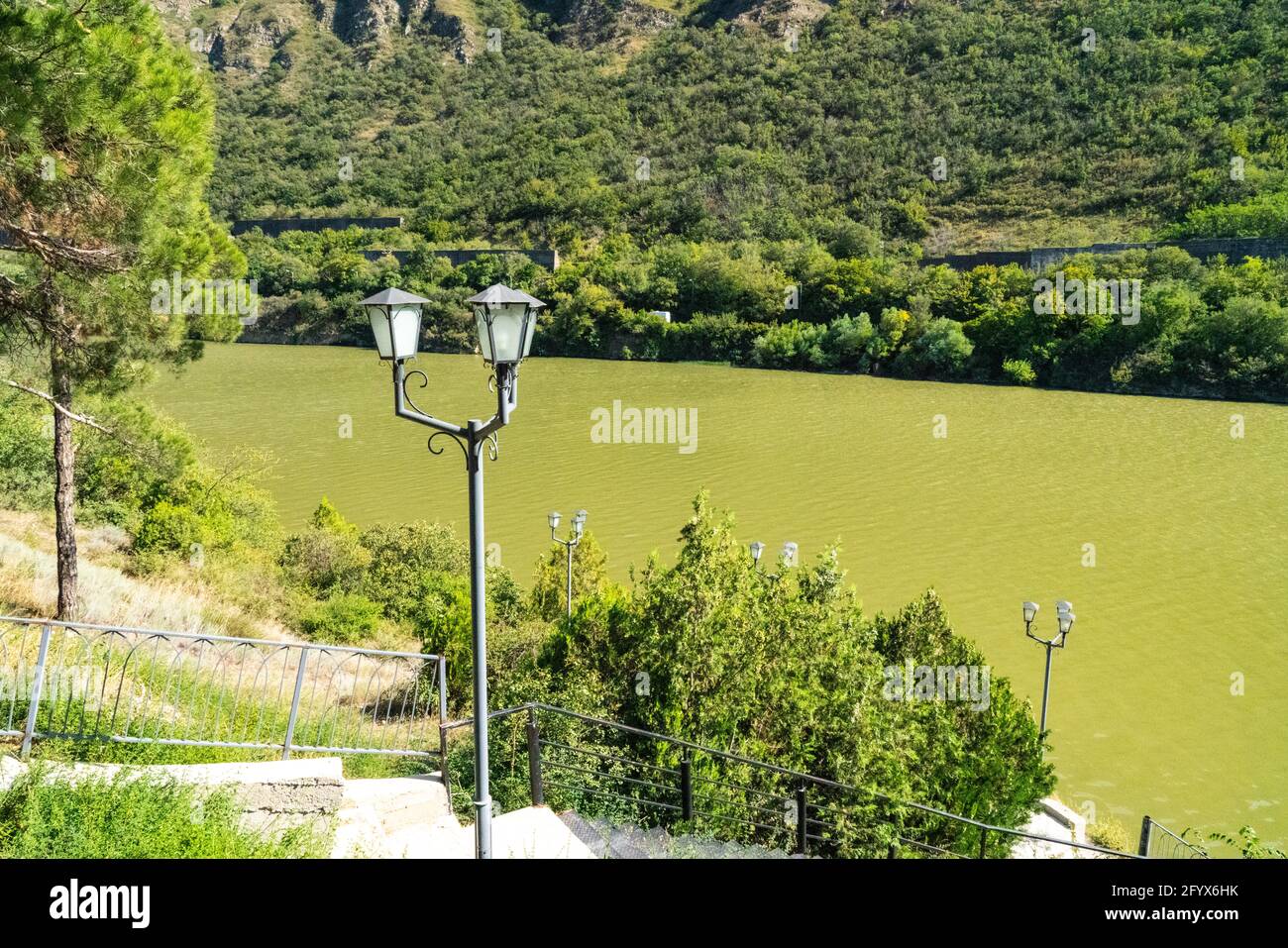 Lamp post on the background of green water Stock Photo - Alamy