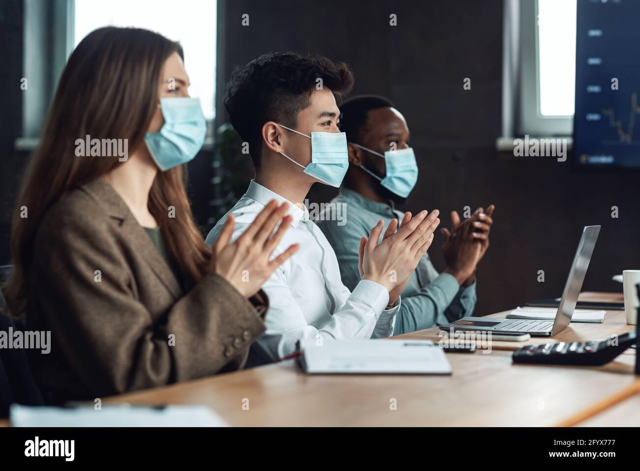 Colleagues having meeting in boardroom, clapping hands Stock Photo - Alamy