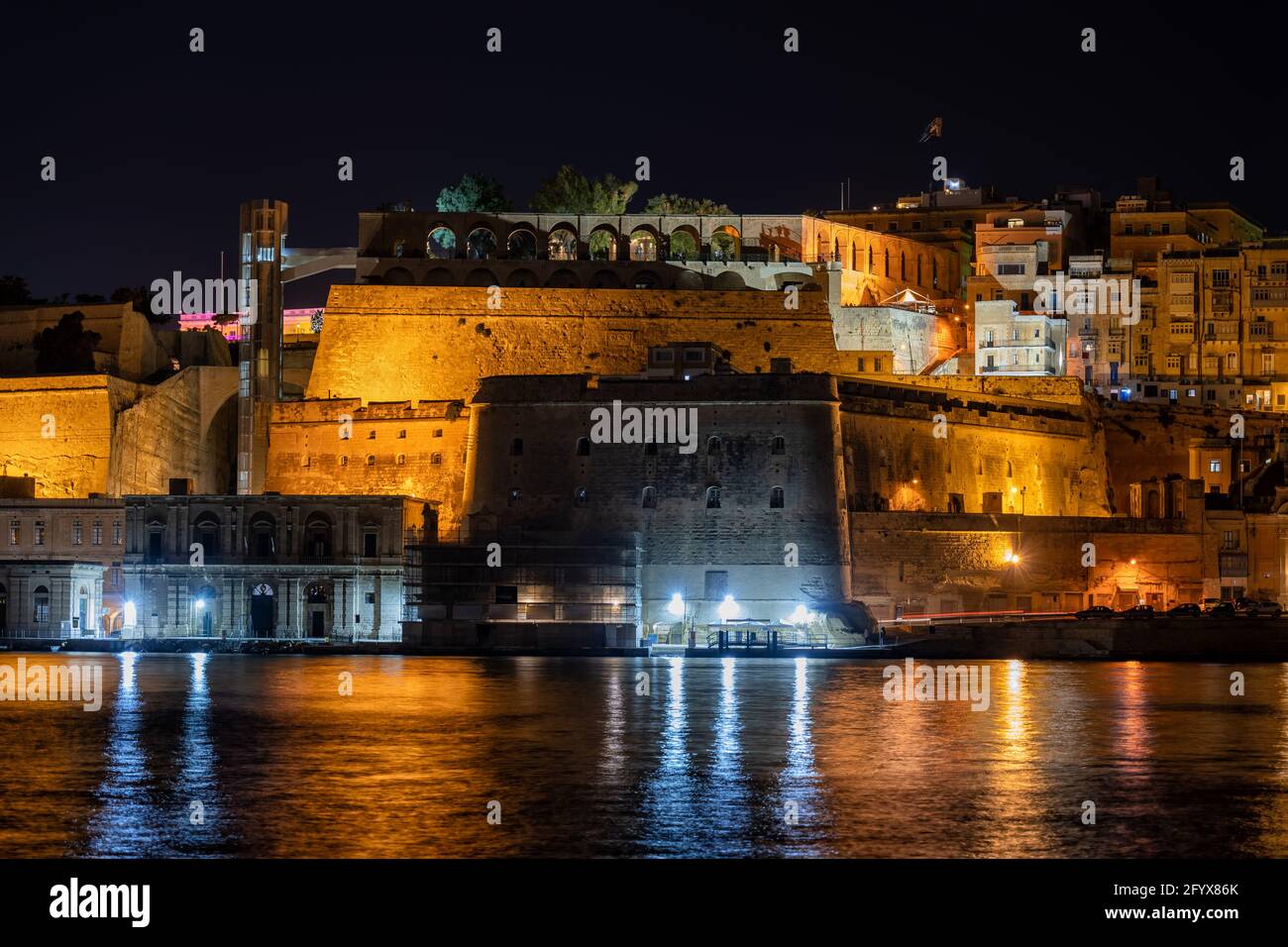 Valletta at night in Malta, city wall fortifications and Upper Barrakka ...