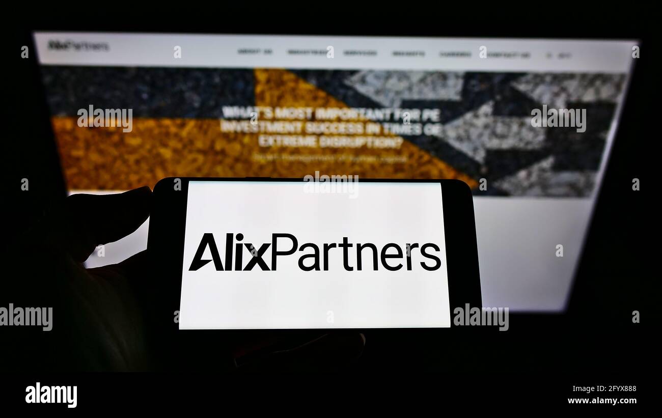 Person holding mobile phone with business logo of US consulting firm ...