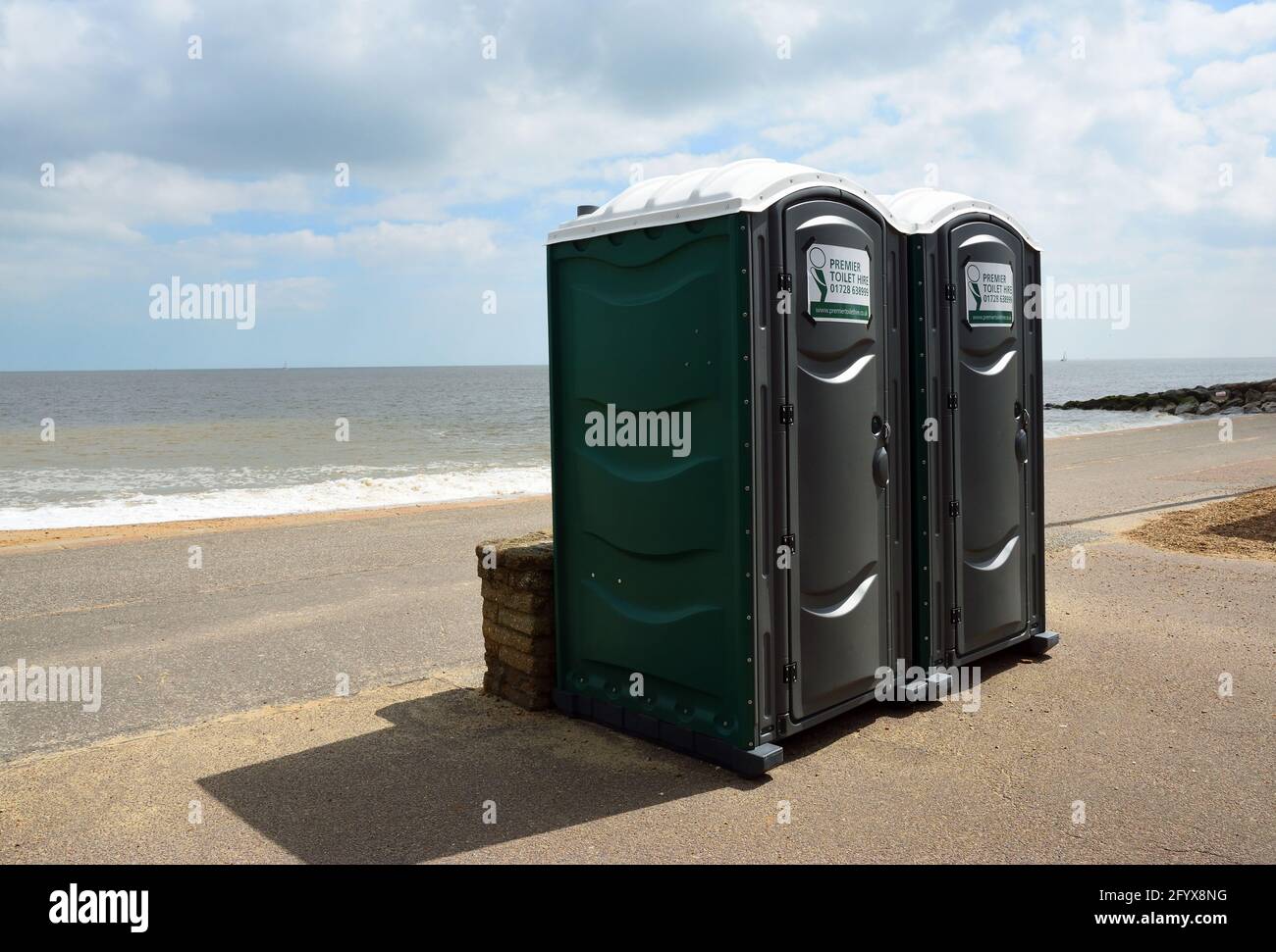 Two portableble cubicles on seafront promenade with the ocean in the ...