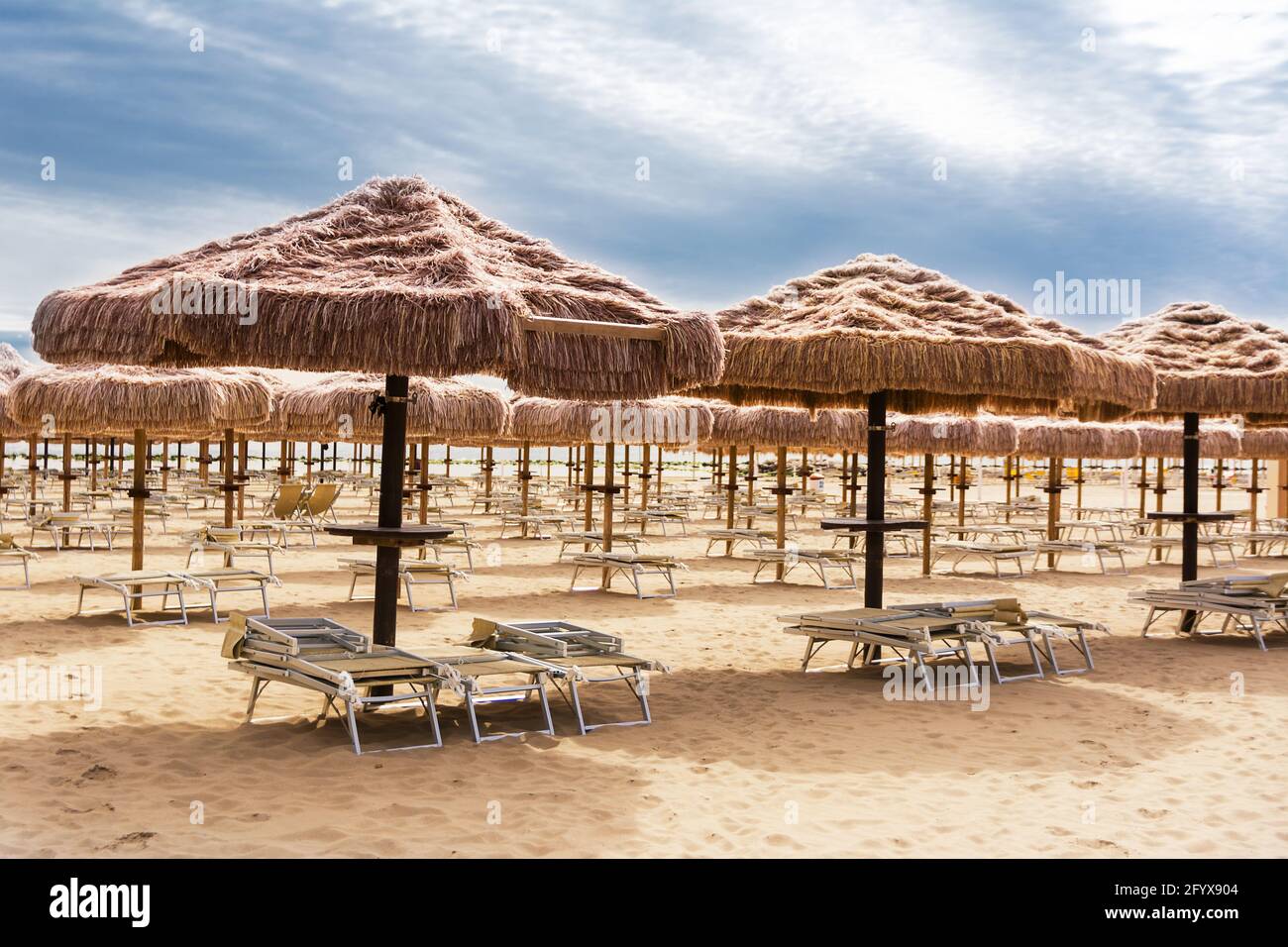 Palm umbrellas on the beach in Pescara (Abruzzo-Italy Stock Photo - Alamy