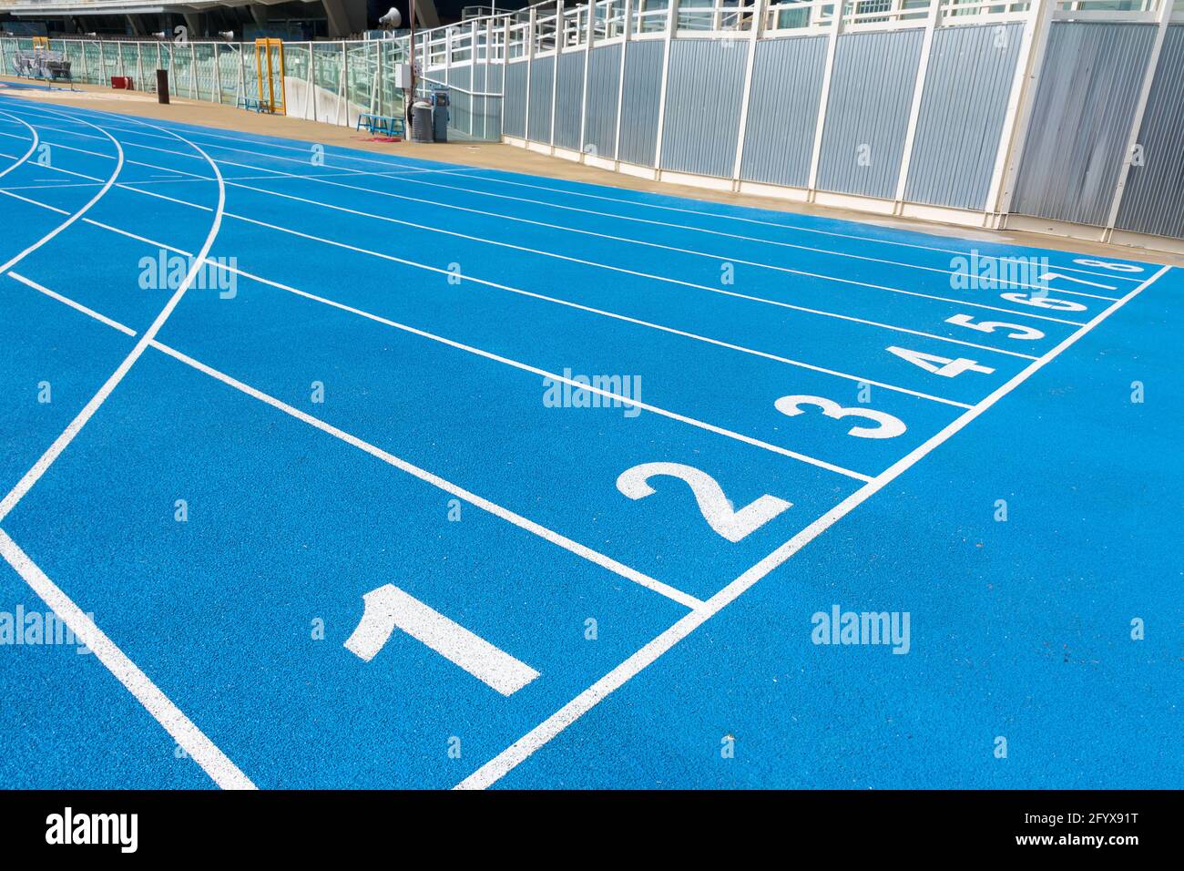 Starting line for the race inside a stadium with the 8 starting blocks ...