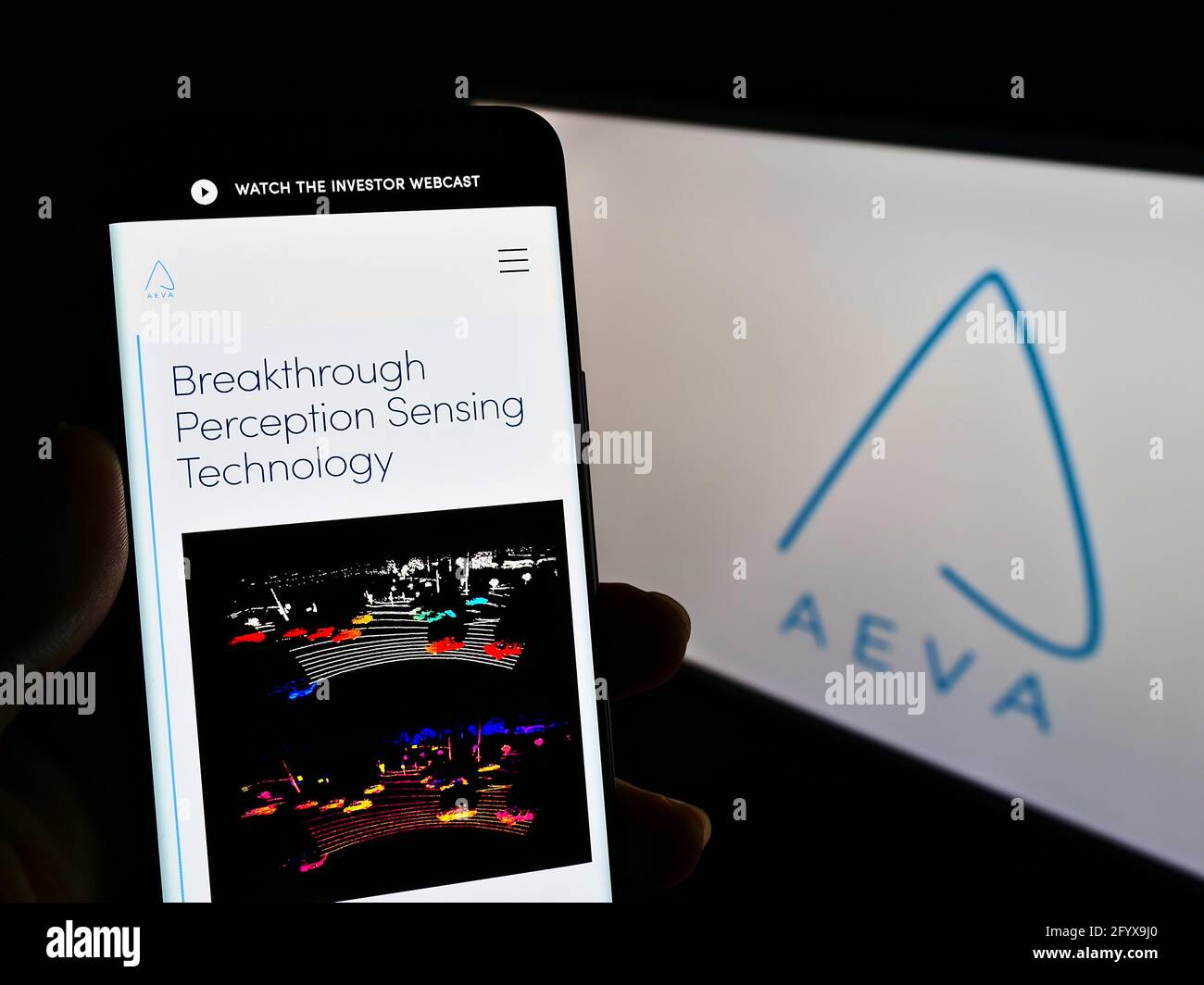 Person holding smartphone with webpage of American autonomous machine ...