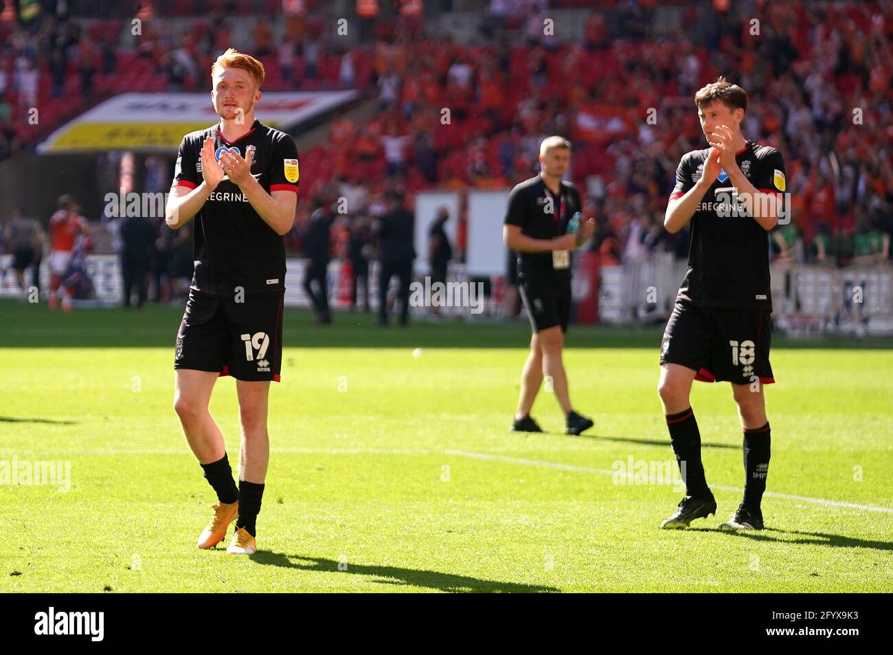 Lincoln City's Callum Morton (left) and Conor McGrandles applaud fans ...