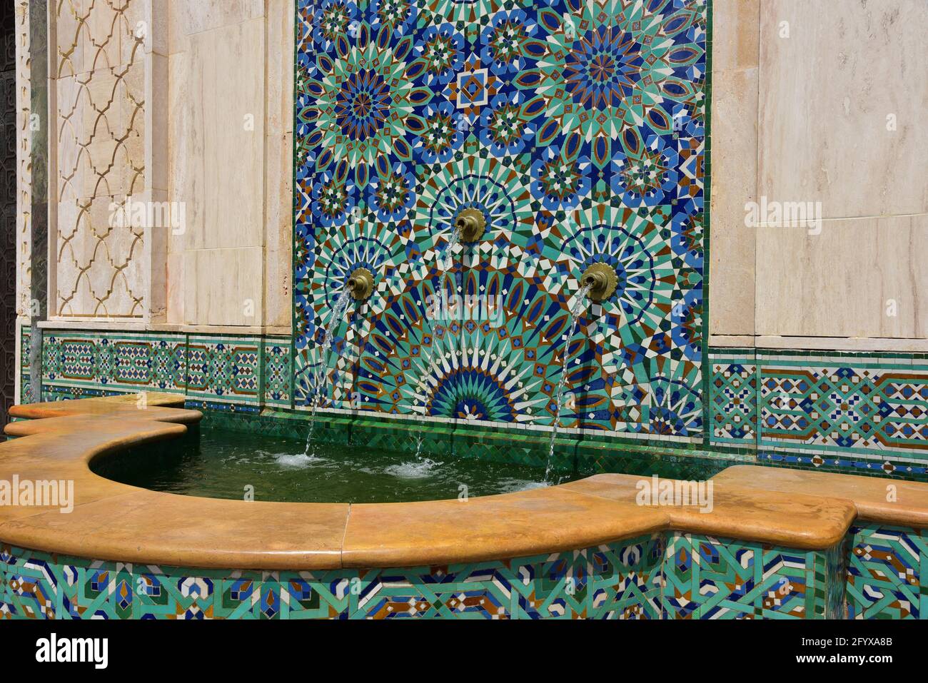 Moroccan fountain decorated with Zellij tiles on the exterior of the ...